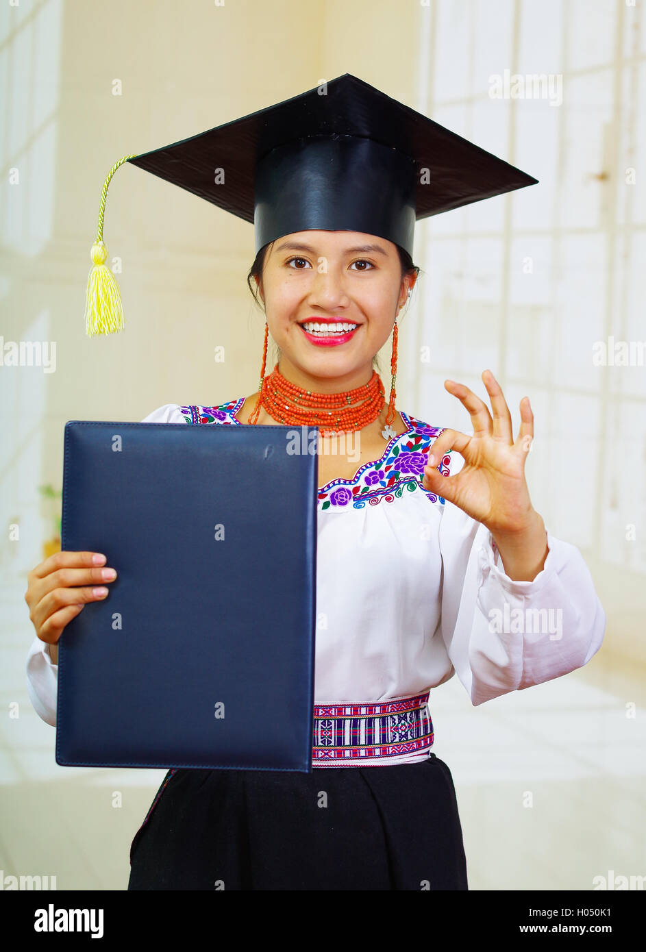 Young female student wearing traditional blouse and graduation hat ...