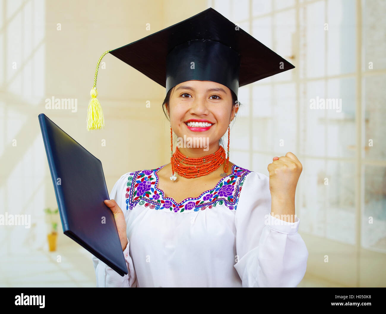 Young female student wearing traditional blouse and graduation hat ...