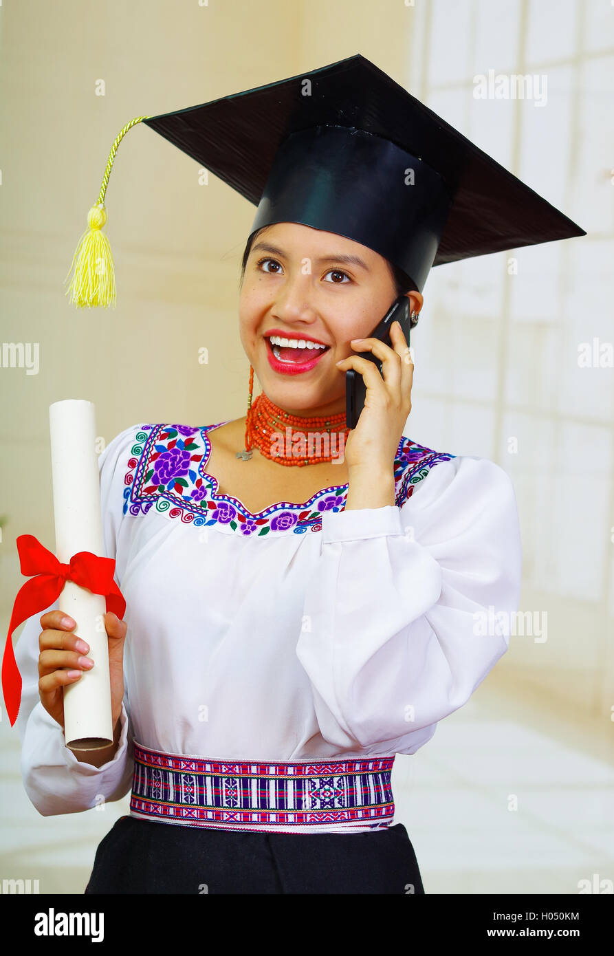 Young female student wearing traditional blouse with graduation hat ...