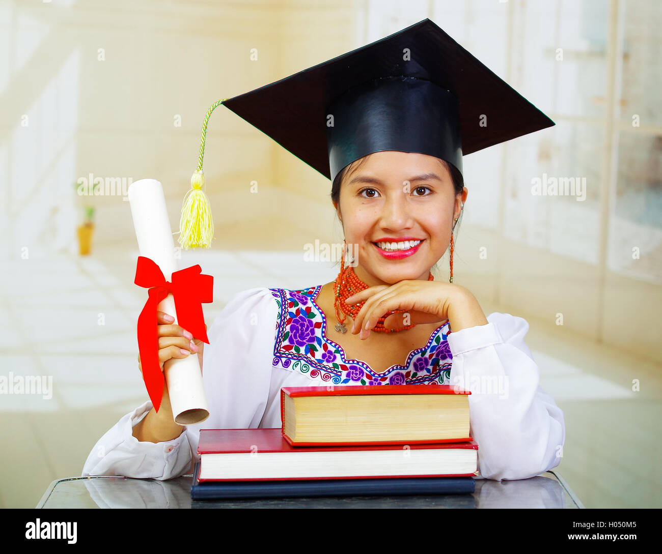 Young female student wearing traditional blouse and graduation hat ...