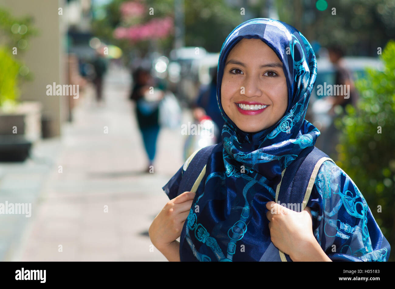 Beautiful young muslim woman wearing blue colored hijab and backpack ...