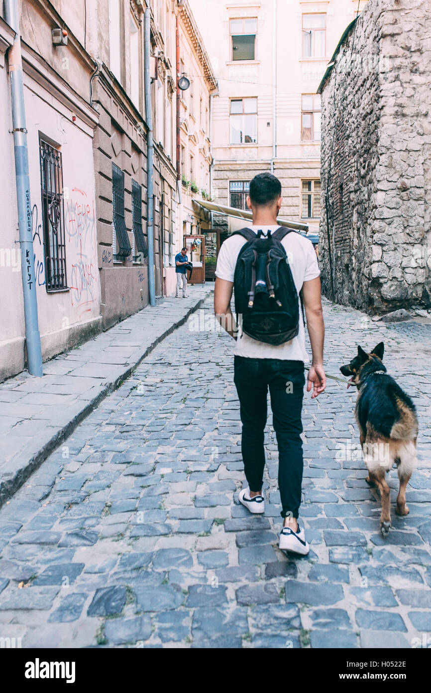 man walking with a dog on the street Stock Photo - Alamy