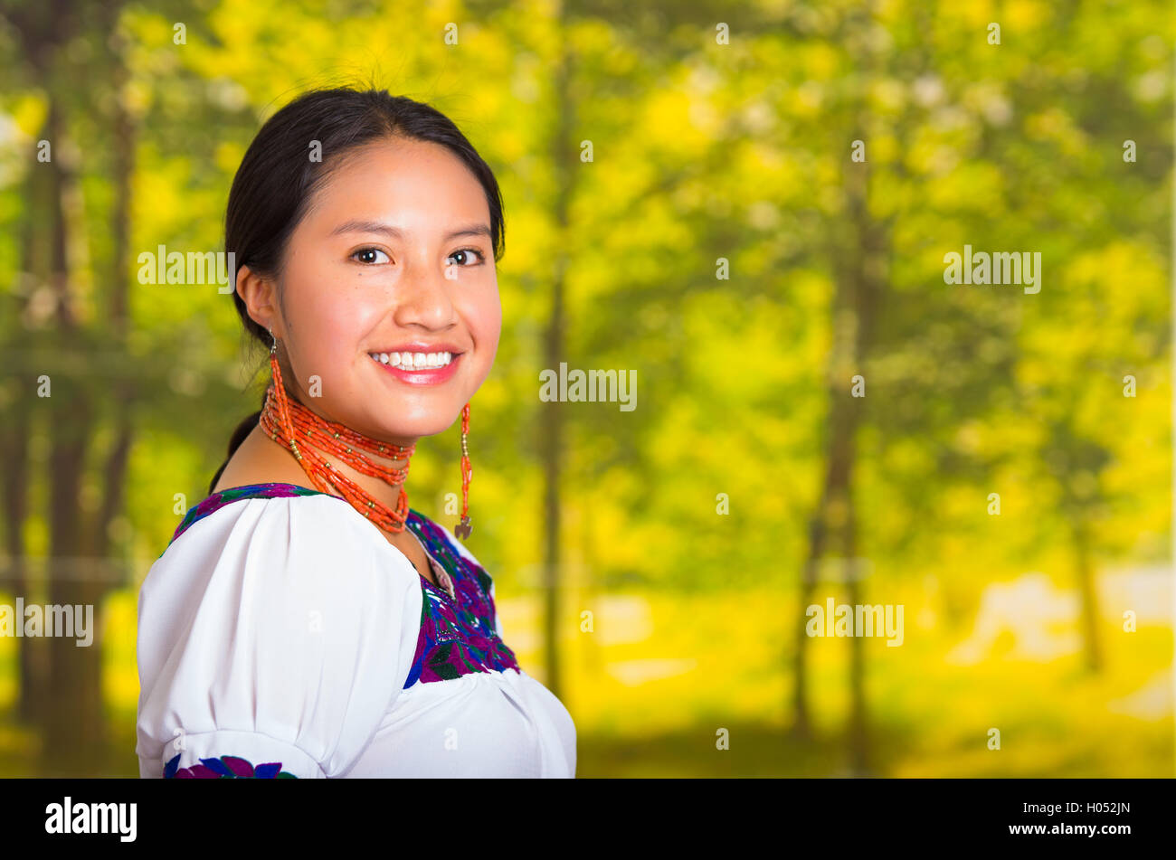 Beautiful young woman wearing traditional andean blouse with necklace ...