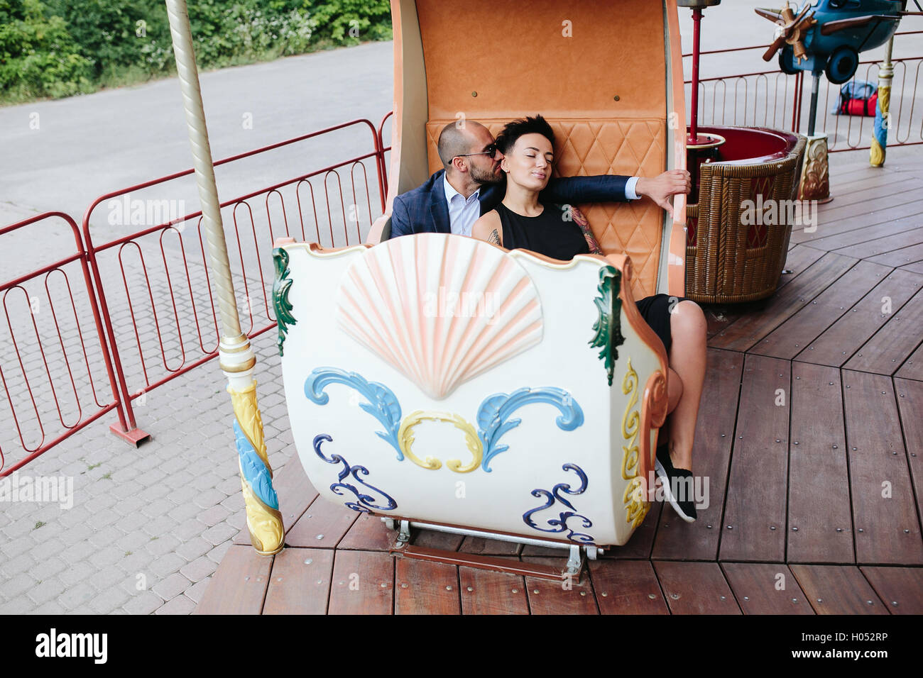Adult man and woman on merry go round carousel hi-res stock photography ...