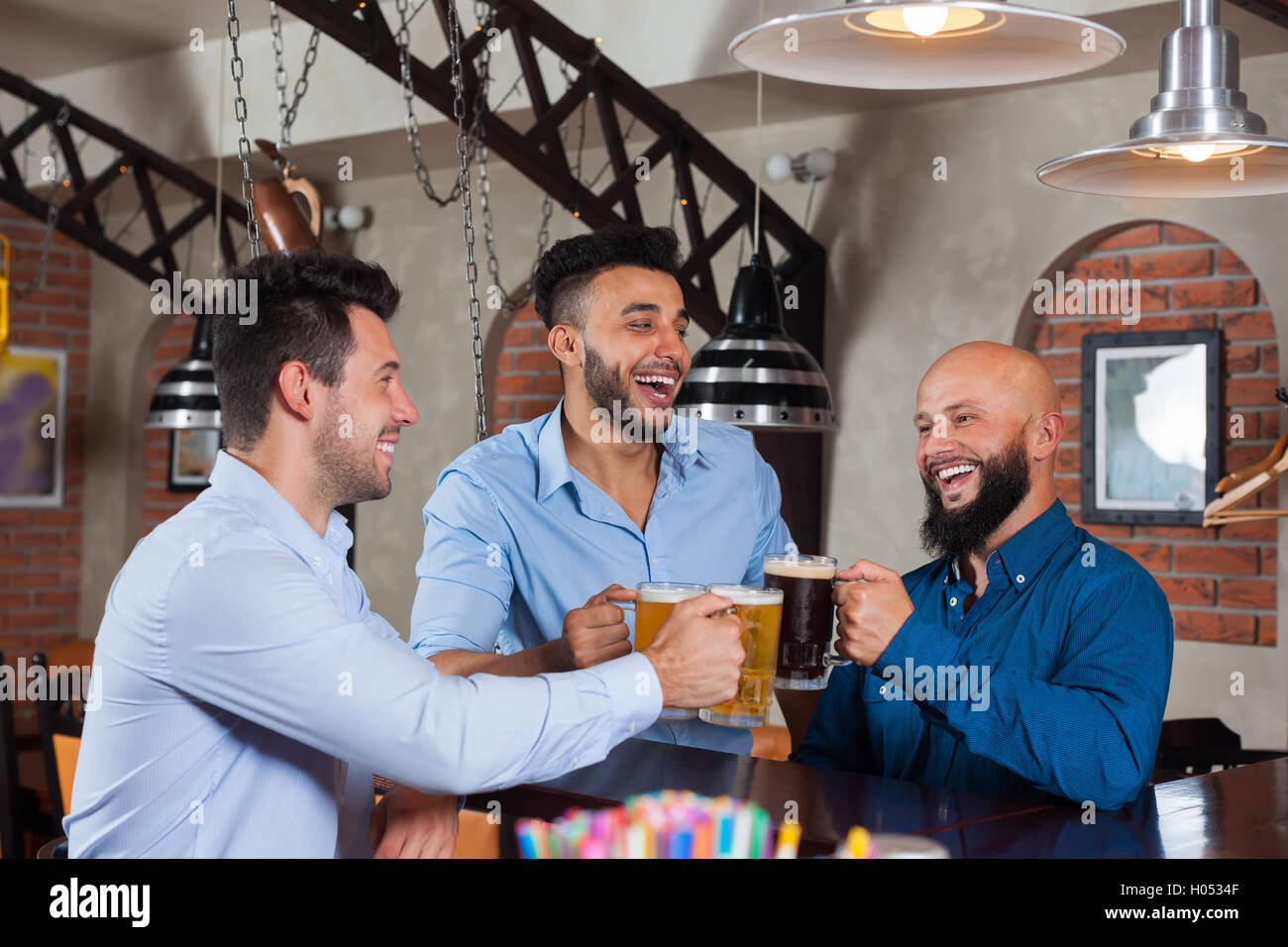 Three Man In Bar Clink Glasses Toasting, Drinking Beer Hold Mugs, Mix ...