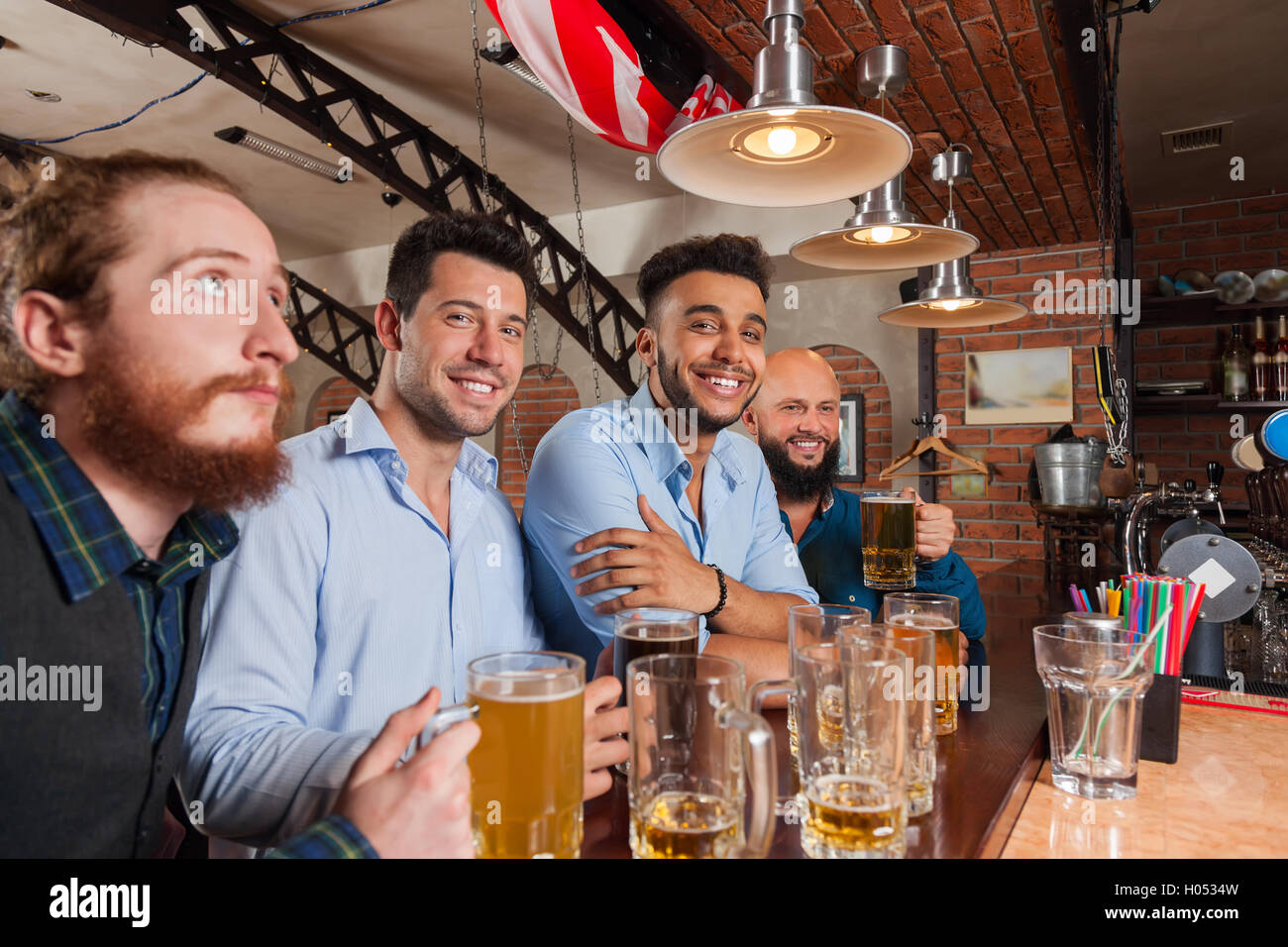 Man Group In Bar Hold Glasses Happy Smiling, Drinking Beer, Mix Race ...