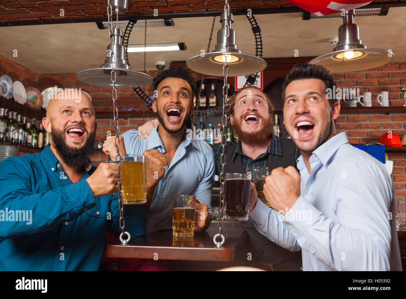 Man Group In Bar Screaming And Watching Football, Drinking Beer Hold ...