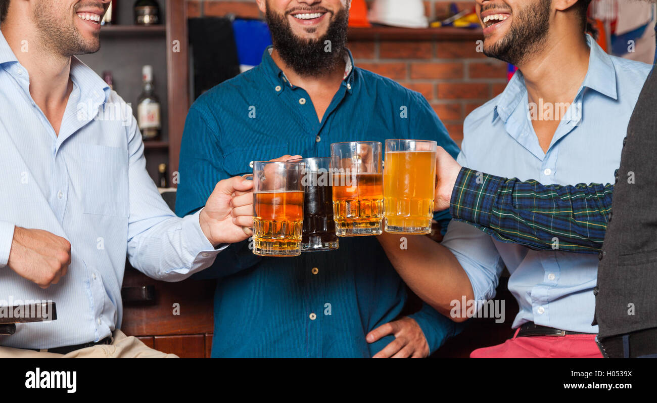 Man Group In Bar Clink Glasses Toasting Sit At Table, Drinking Beer ...