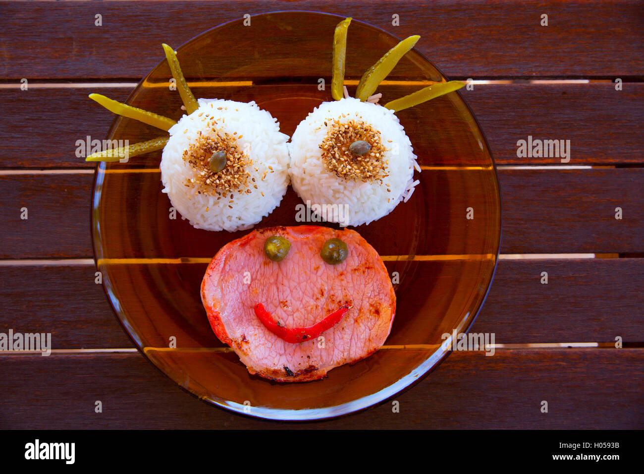 Funny kid food with rice and meat smiley face Stock Photo - Alamy