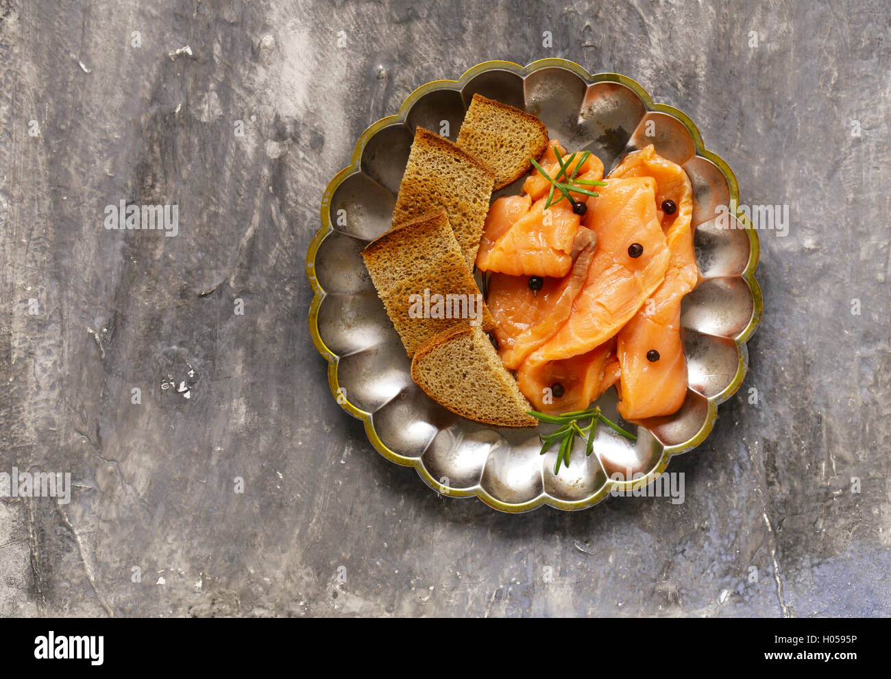 salty salmon red fish with black pepper and rosemary Stock Photo - Alamy