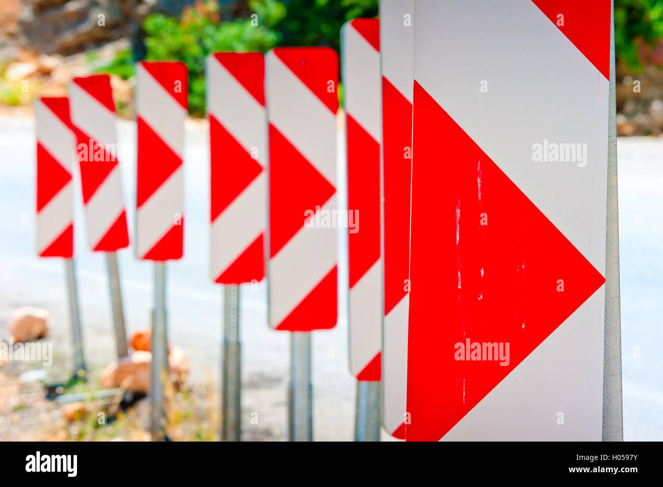number of road signs warning of the dangerous turn Stock Photo - Alamy