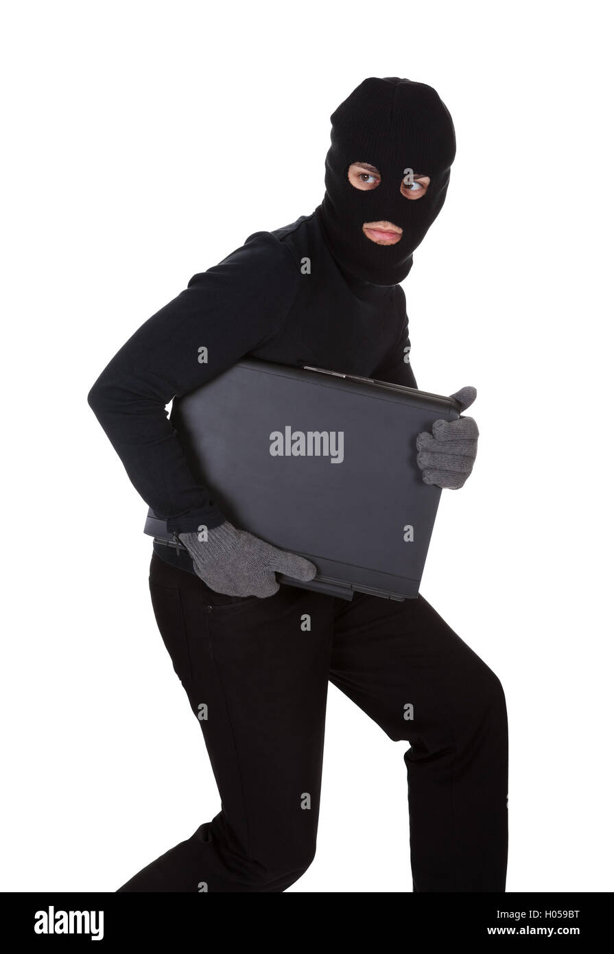 Thief stealing a laptop computer Stock Photo - Alamy