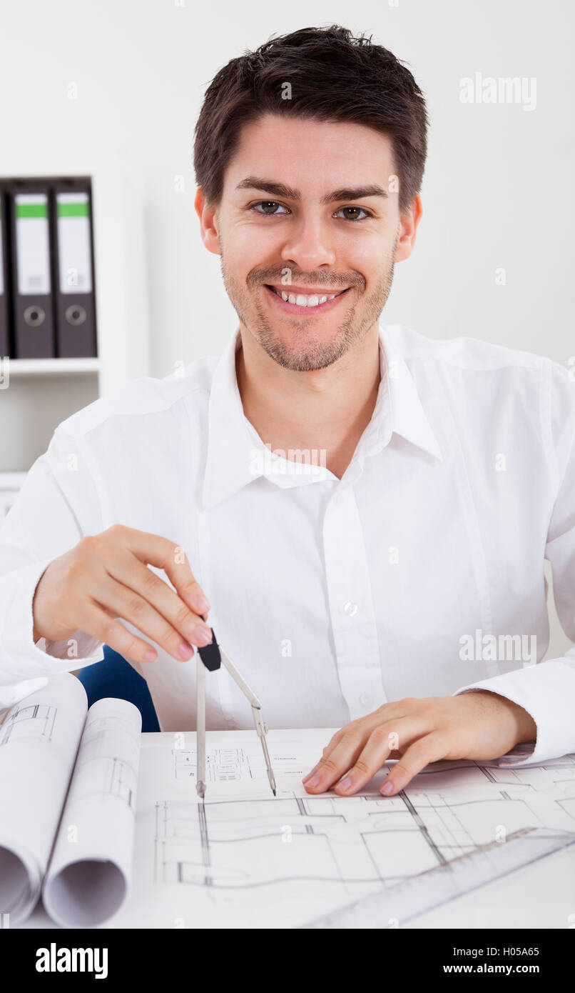 Architect working on blueprints Stock Photo - Alamy