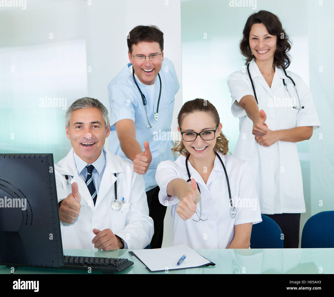 Happy medical team giving a thumbs up Stock Photo - Alamy