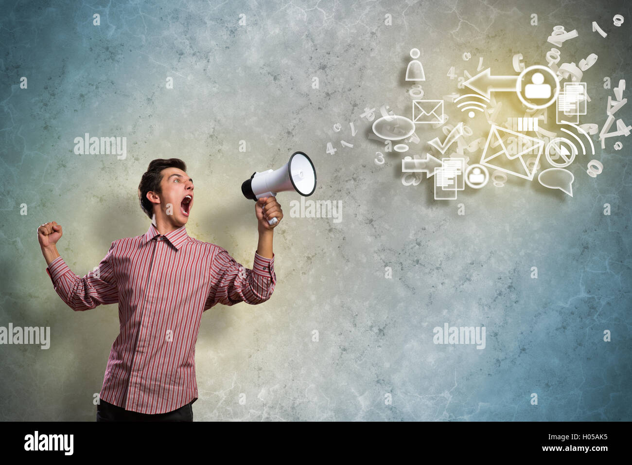 Portrait of a young man shouting using megaphone Stock Photo - Alamy