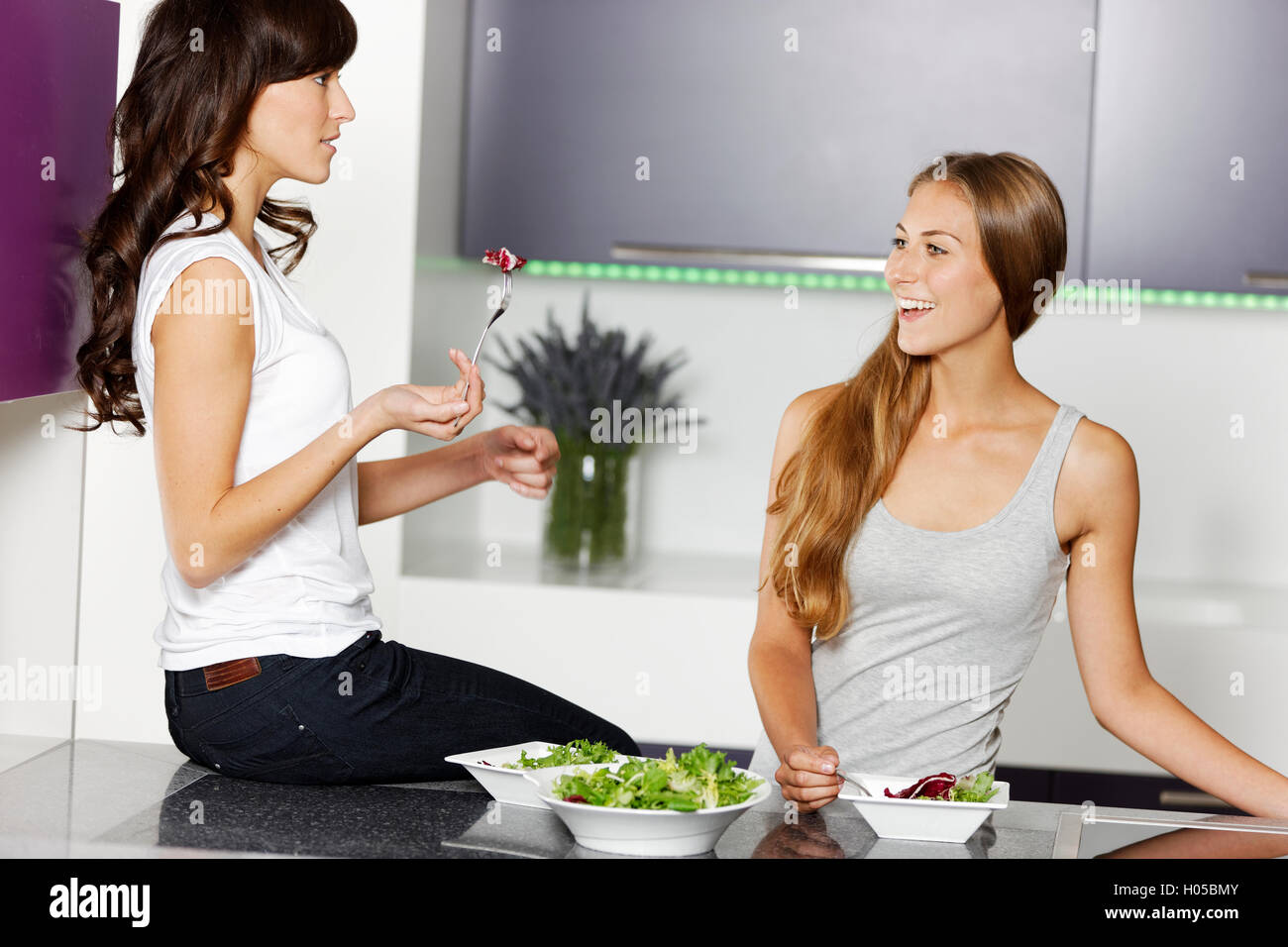 Two friends making salad Stock Photo - Alamy