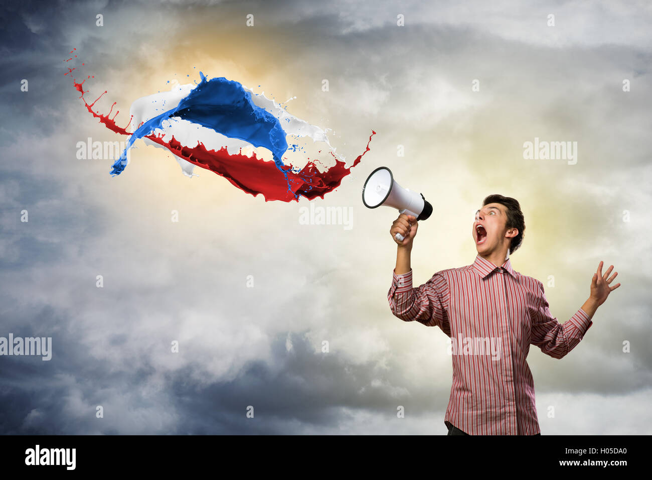Portrait of a young man shouting using megaphone Stock Photo - Alamy