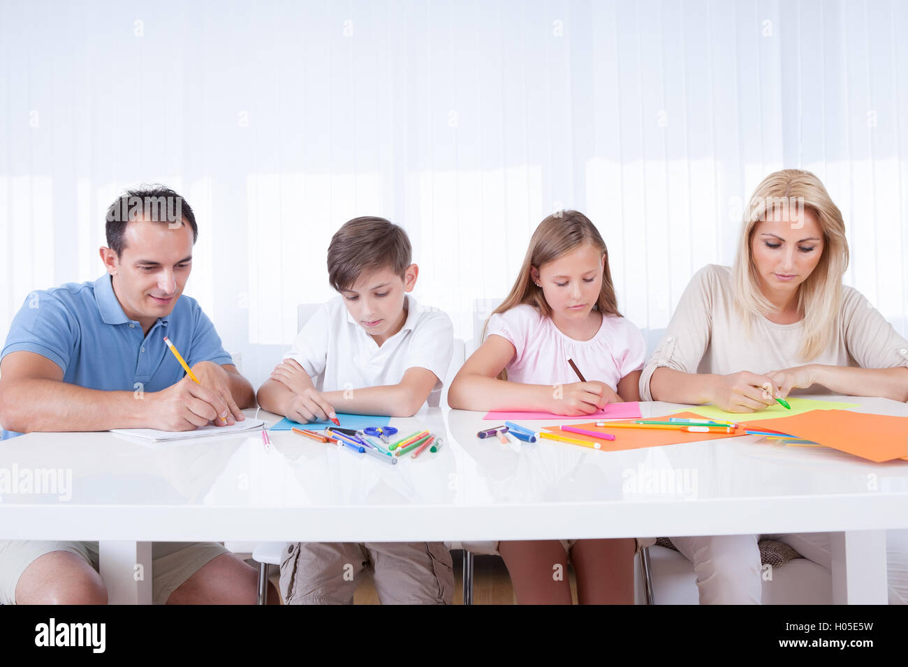 Family Drawing Together With Colorful Pencils Stock Photo - Alamy