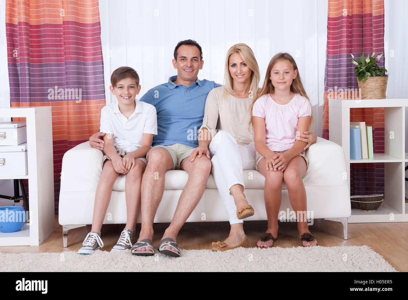 A Happy Family With Two Children Stock Photo - Alamy