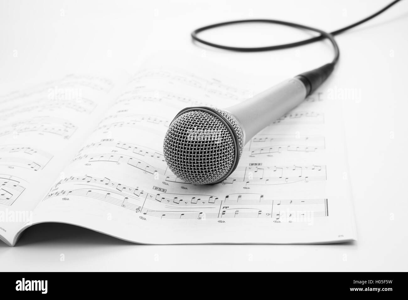 microphone lying on the musical book Stock Photo - Alamy