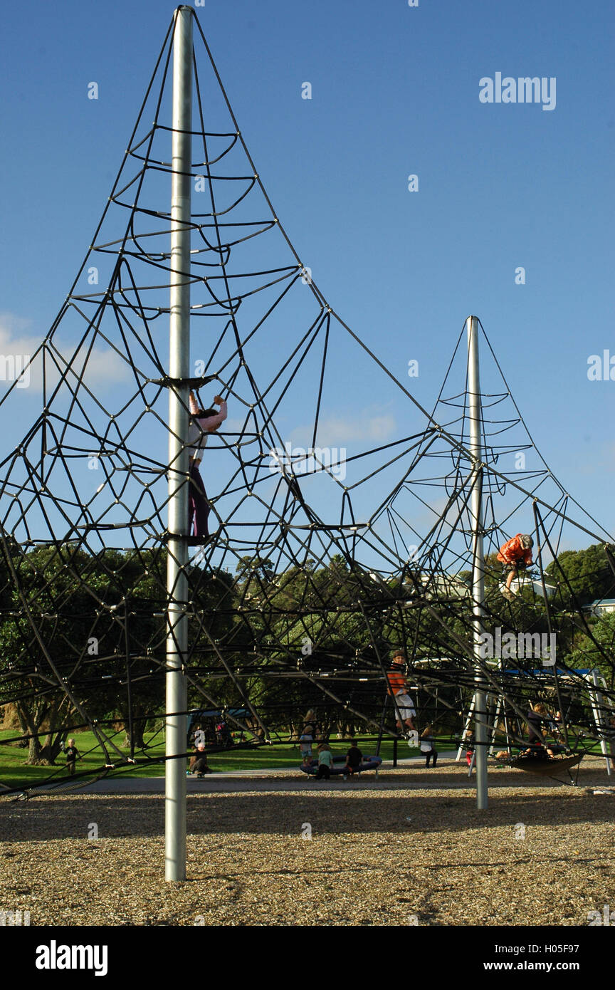 Children climbing poles and ropes on playground Stock Photo - Alamy
