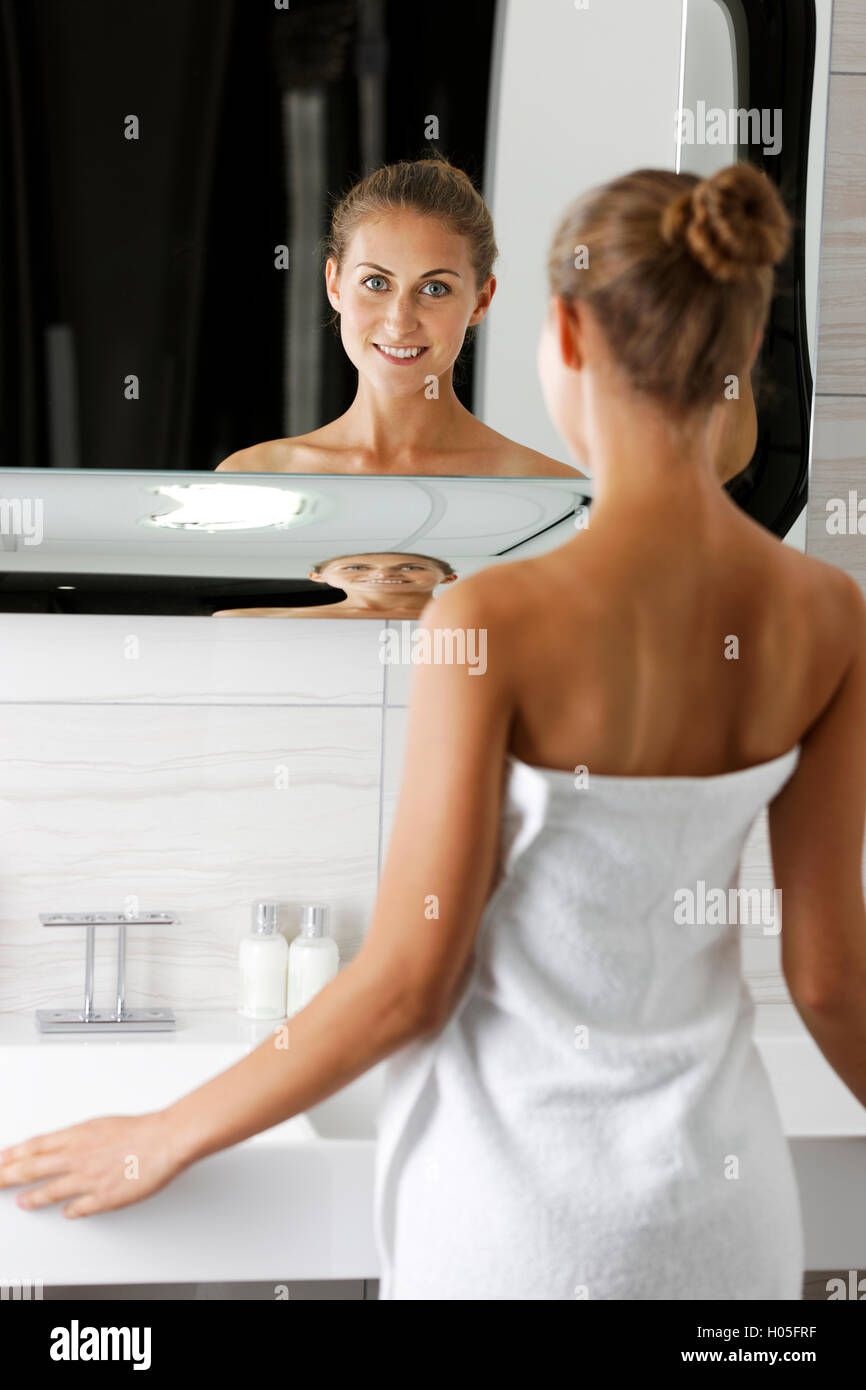 Woman getting ready in bathroom Stock Photo - Alamy