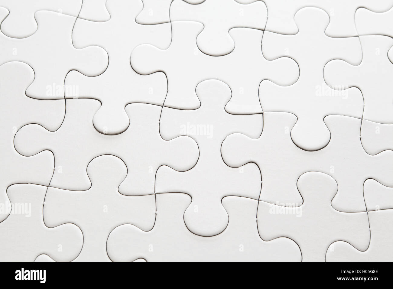 Complete white puzzle Stock Photo - Alamy