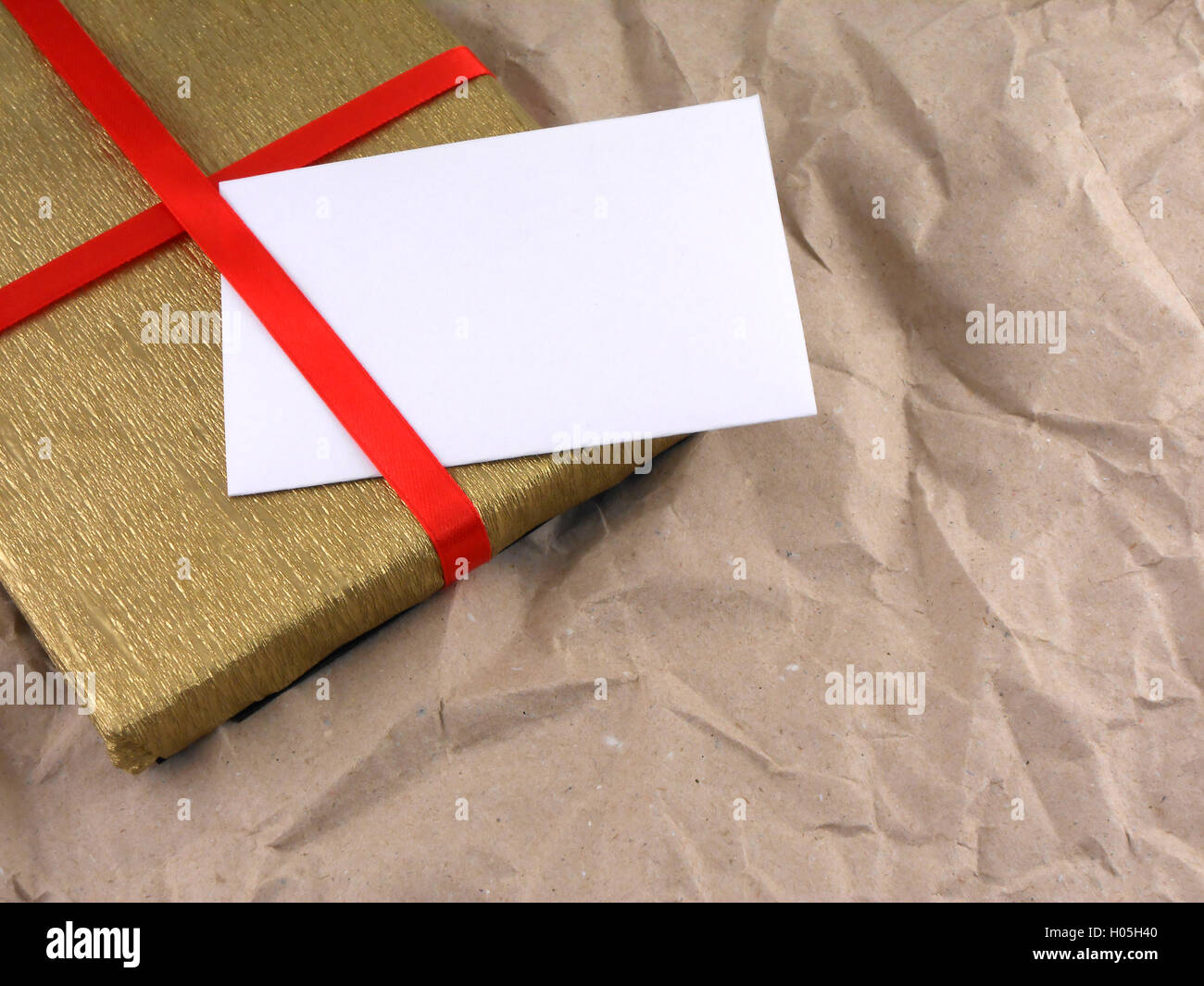 golden gift box with red bow on vintage old paper Stock Photo - Alamy