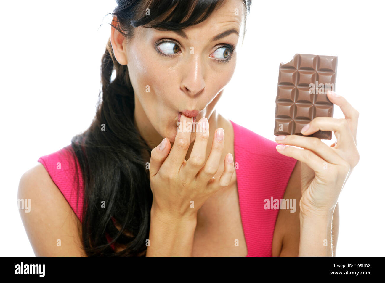 Woman eating chocolate bar Stock Photo - Alamy