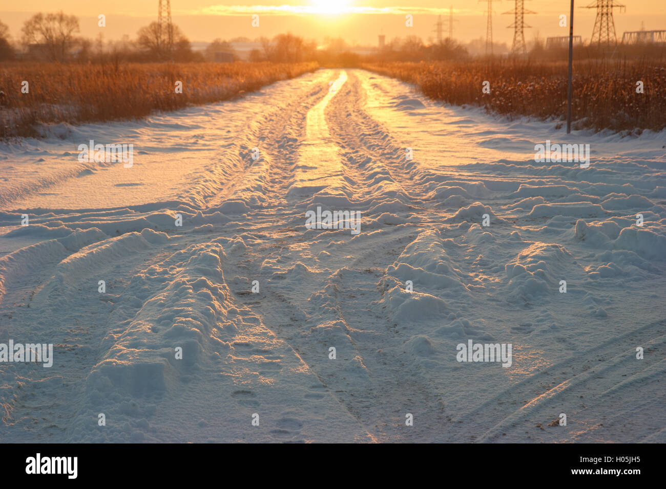 Sunset snowy road Stock Photo - Alamy
