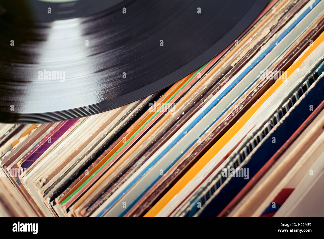 an old dusty collection of vinyls, with one LP at the top Stock Photo ...