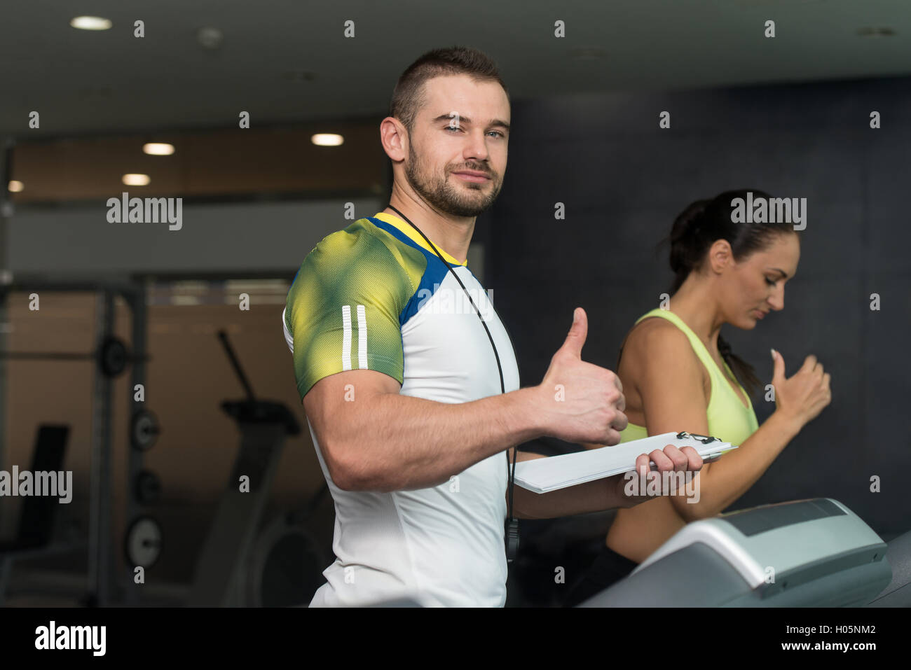 Personal Trainer Showing Ok Sign To Client - Group Of People Exercising ...