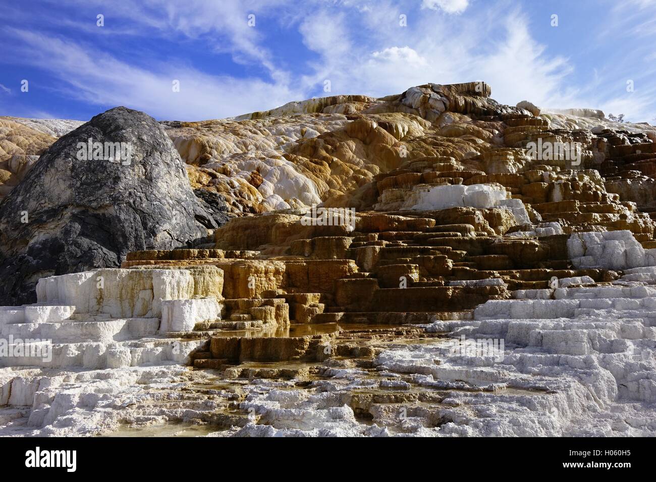 Travertine deposits from hot springs, lower terraces at Mammoth Hot ...
