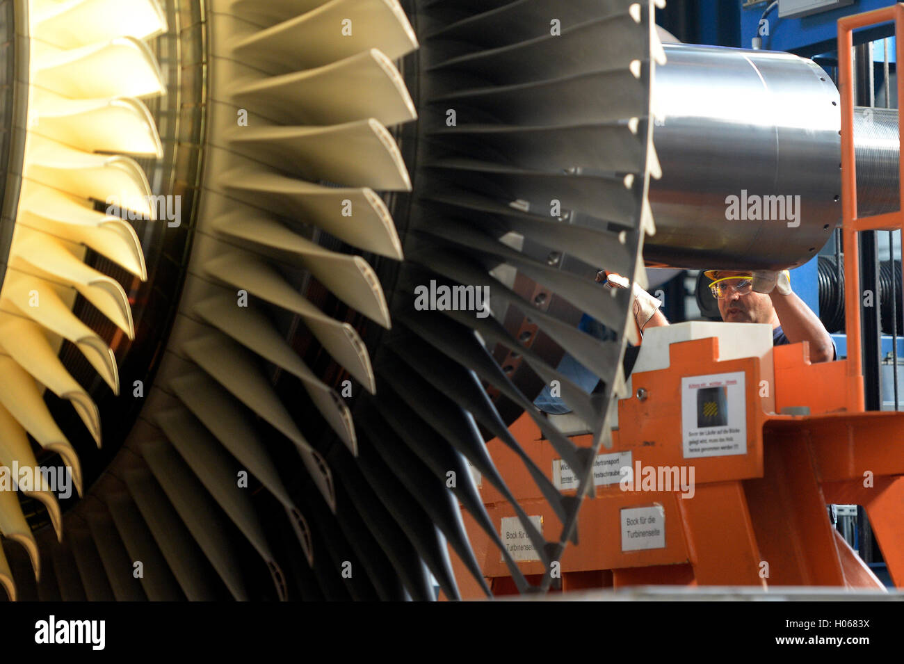 Siemens workers monitor a turbine rotor in a gas turbine in Berlin ...