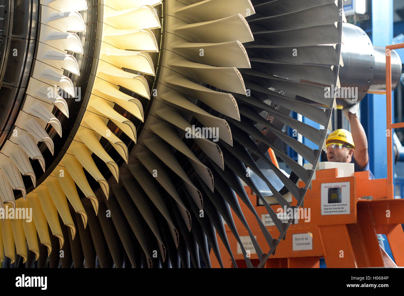 Siemens workers monitor a turbine rotor in a gas turbine in Berlin ...