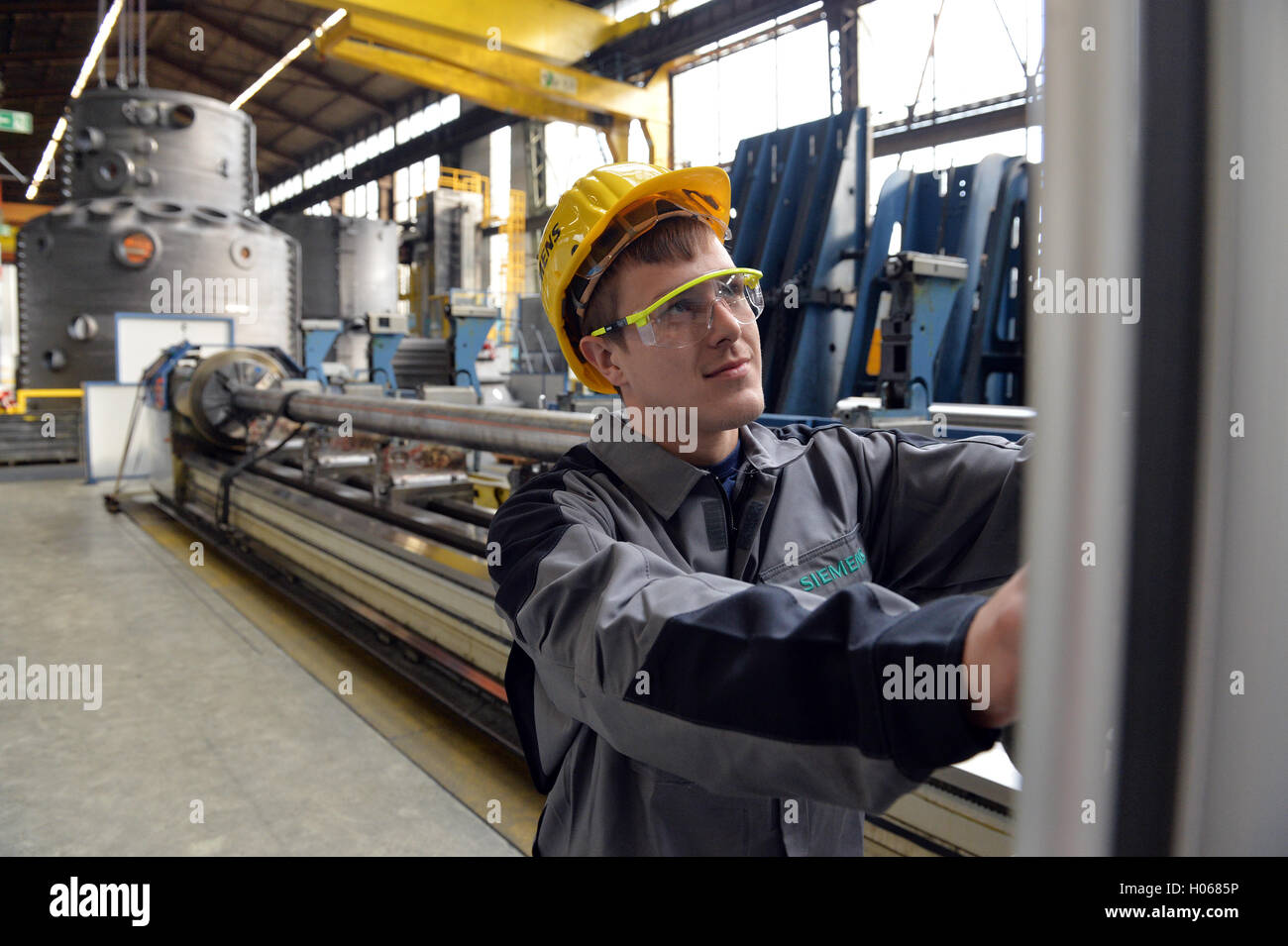 Berlin, Germany. 16th Sep, 2016. A Siemens worker programs a CNC engine ...