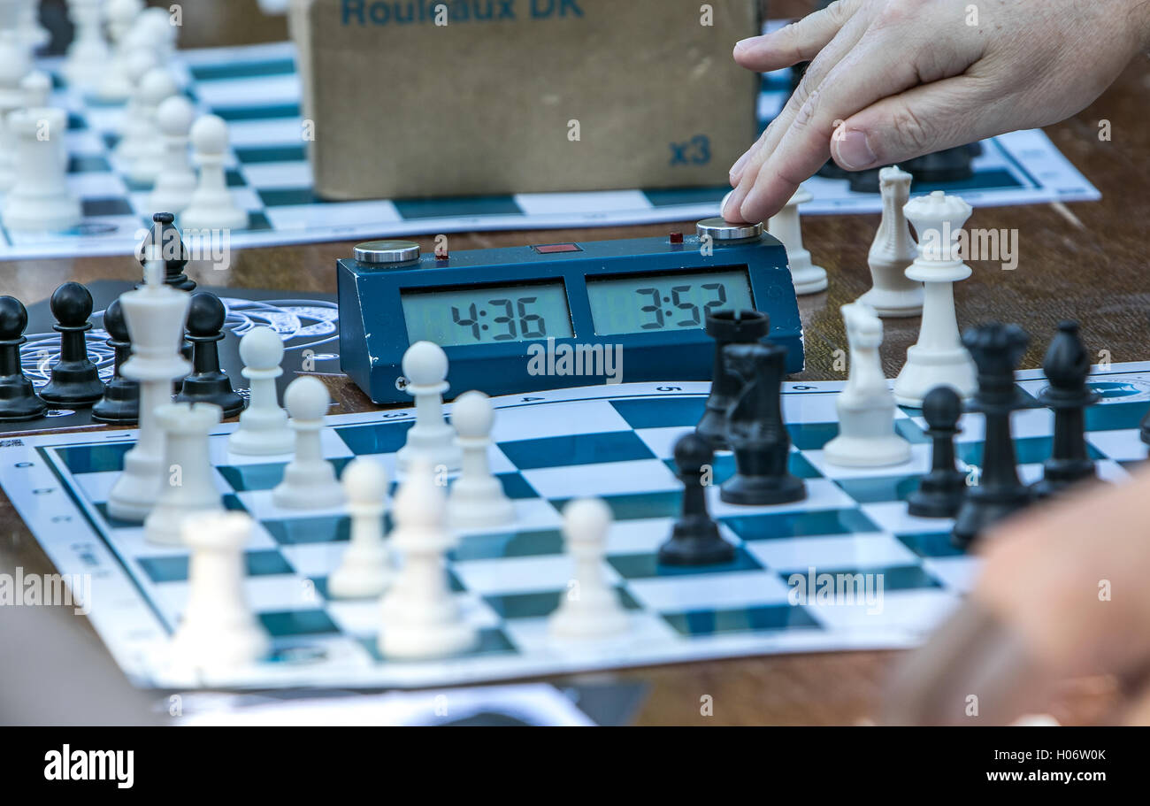 A game of chess is underway, one player is completing a move Stock ...