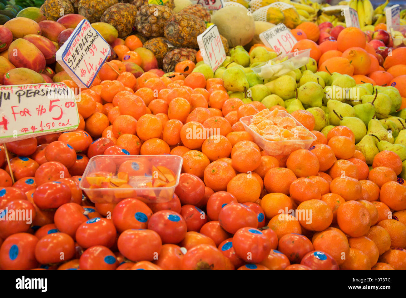 Vibrant colorful fruits on display in fruit market area with priced ...
