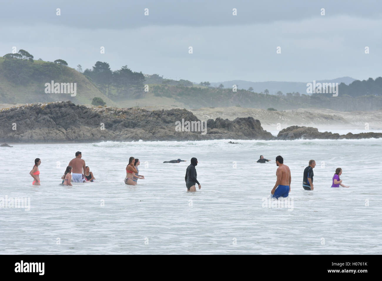 People in swimsuits enjoying oceanic surf waves Stock Photo - Alamy