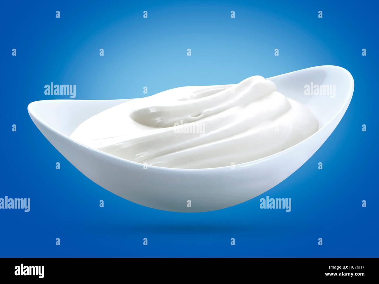 Sour cream in bowl isolated on blue background Stock Photo - Alamy
