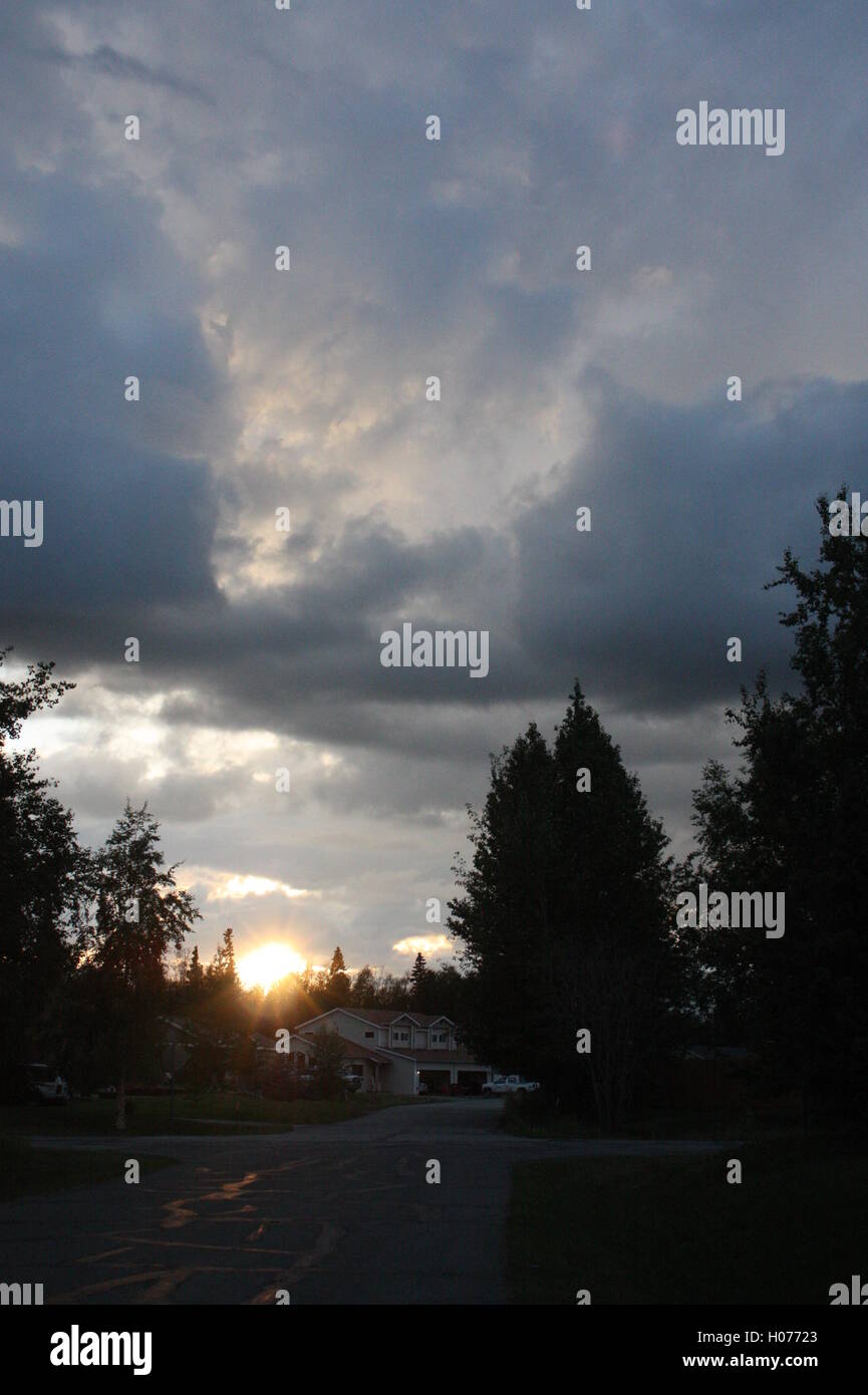 Sun rising over houses in Alaska Stock Photo - Alamy