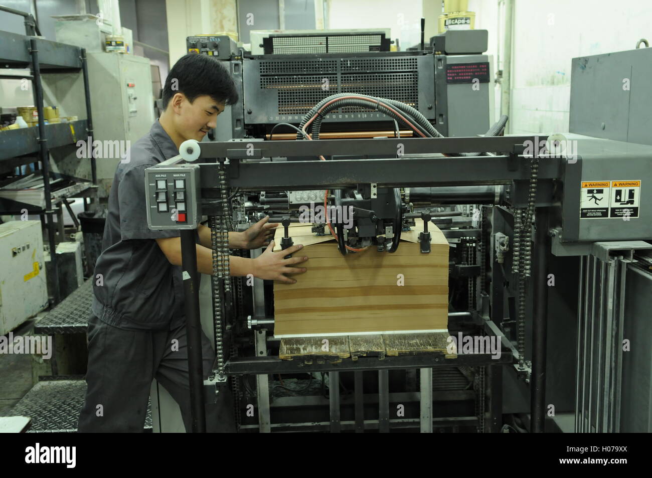 Chinese man working at a modern printing press, Shenzhen, Guangdong ...