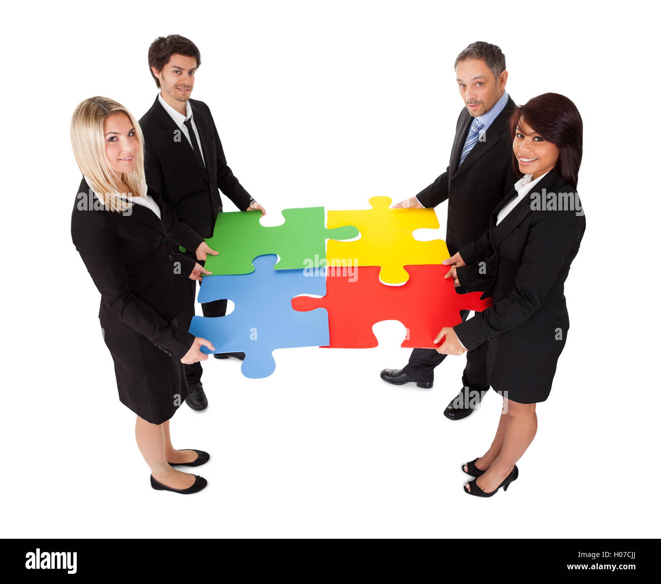 Group of business people assembling puzzle Stock Photo - Alamy