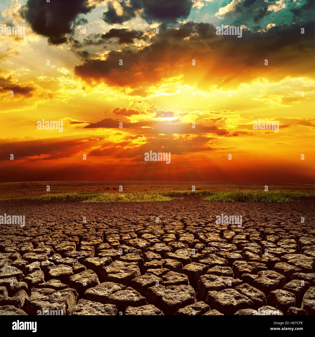 fantastic sunset over cracked earth Stock Photo - Alamy