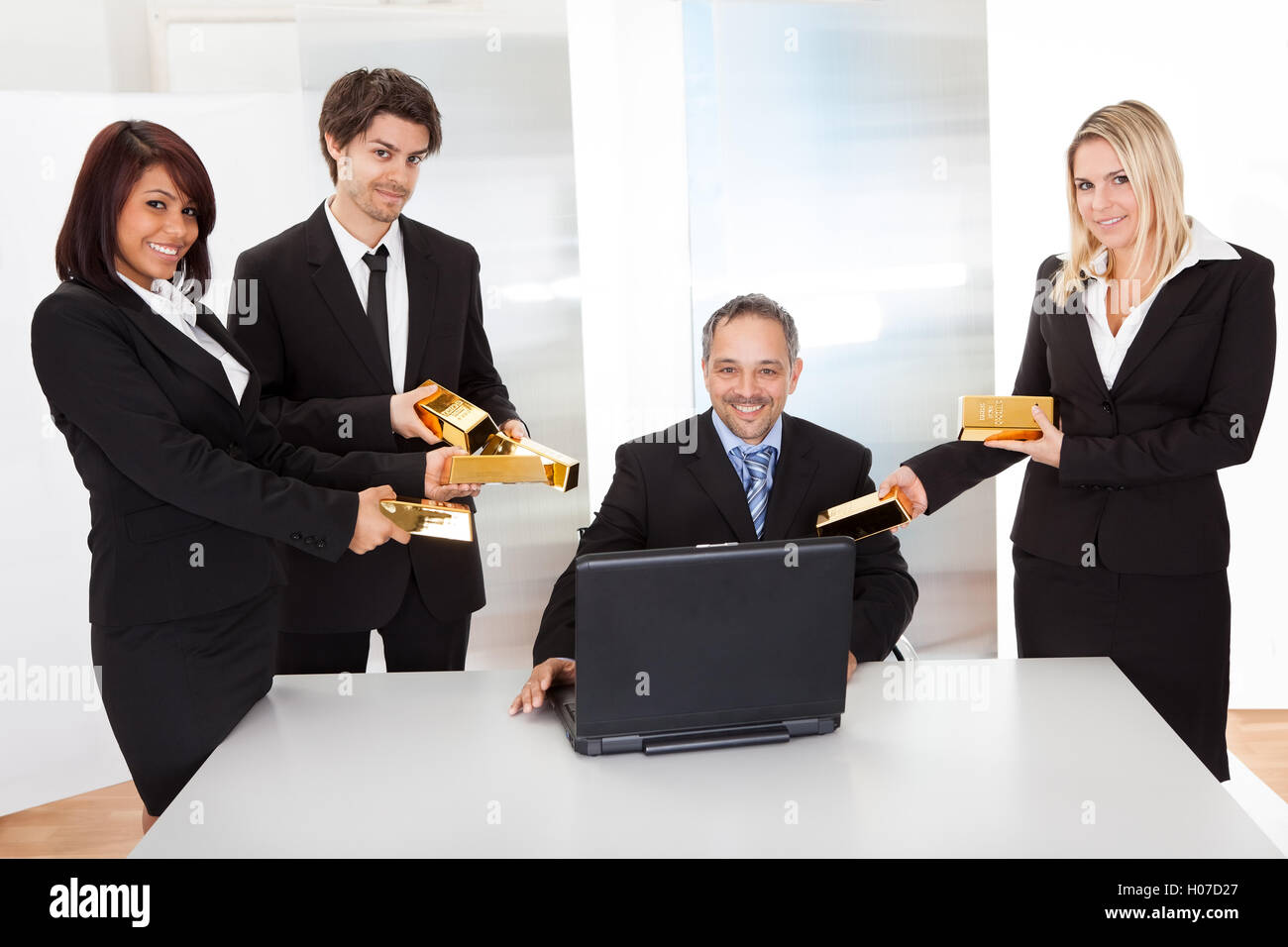 Businessman receiving gold bars Stock Photo - Alamy