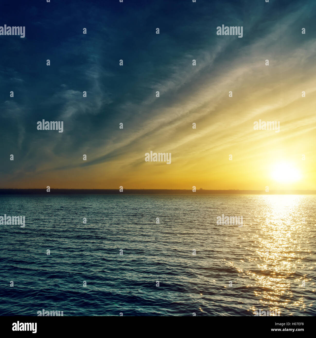 sunset with clouds over water Stock Photo - Alamy