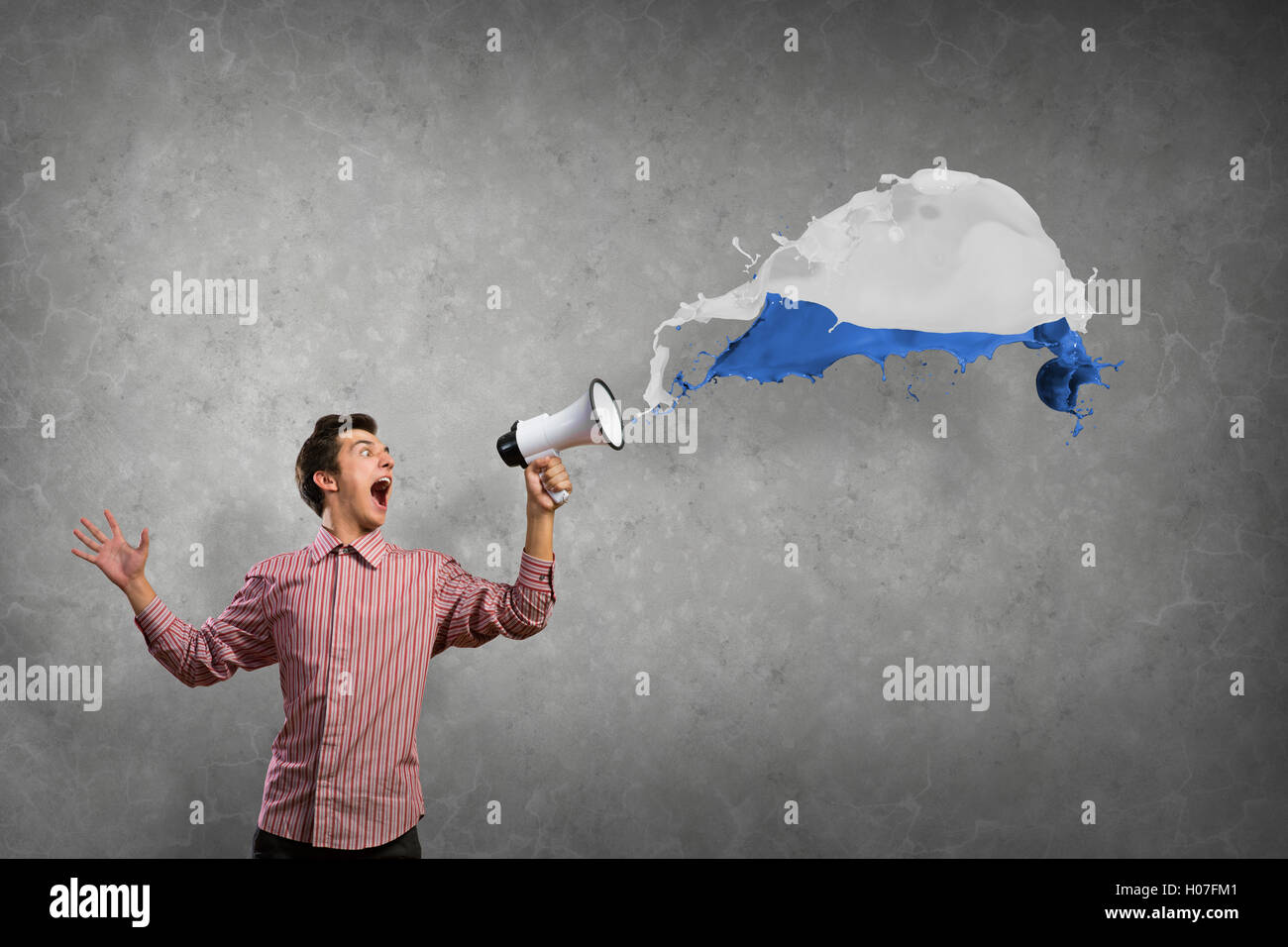 Portrait of a young man shouting using megaphone Stock Photo - Alamy