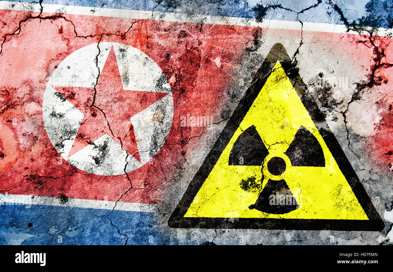 Old cracked wall with radiation warning sign and painted flag Stock ...