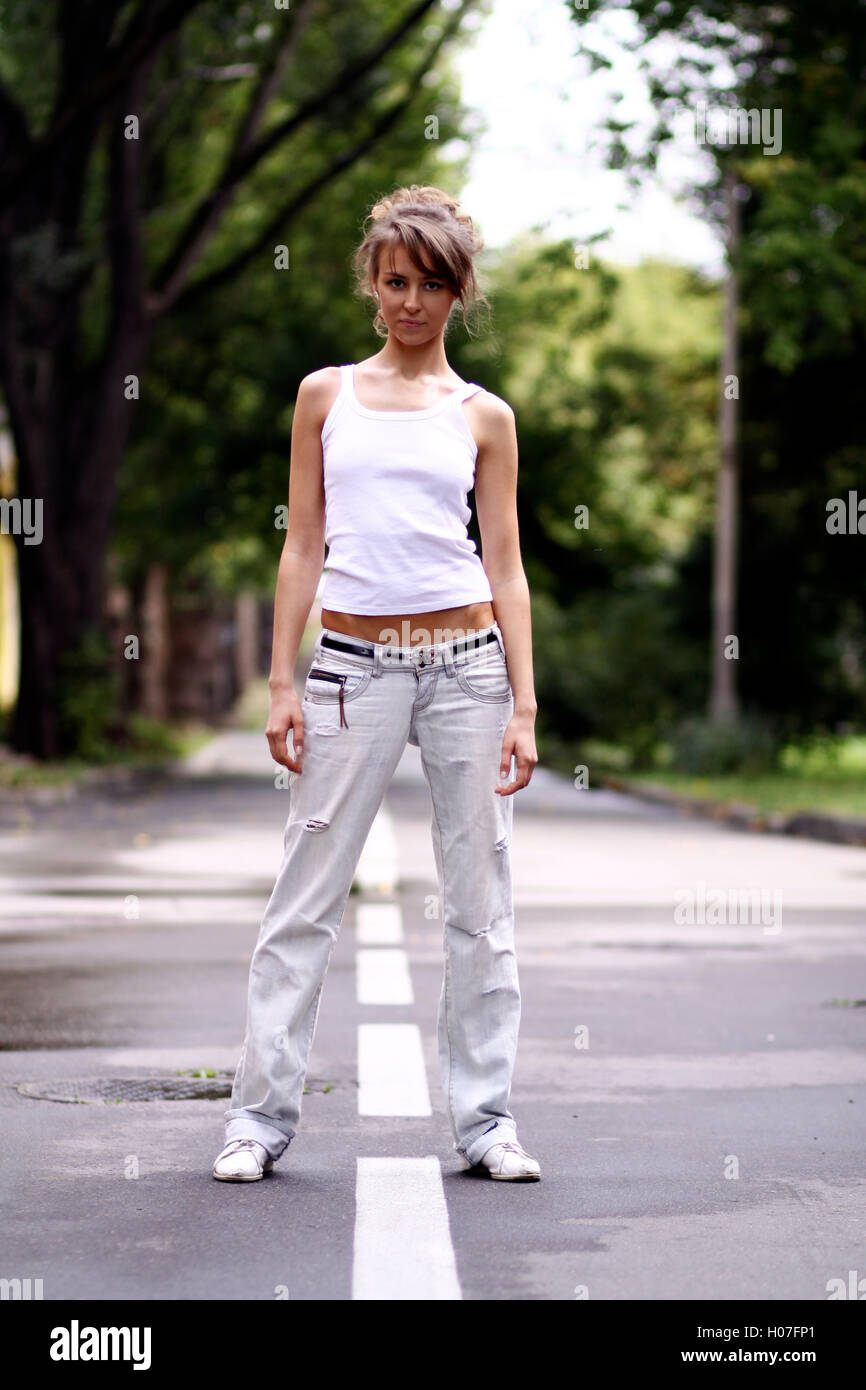 Full length, walking woman in blue jeans Stock Photo - Alamy