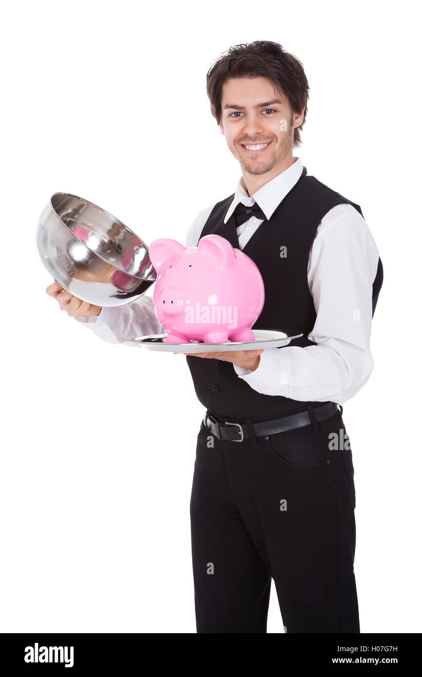 Portrait of a butler with piggybank Stock Photo - Alamy